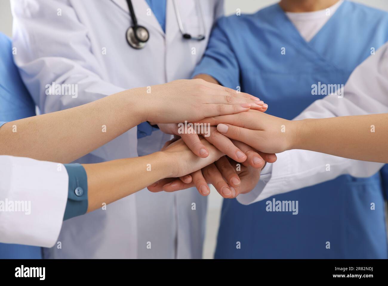 Team of medical doctors putting hands together, closeup Stock Photo - Alamy