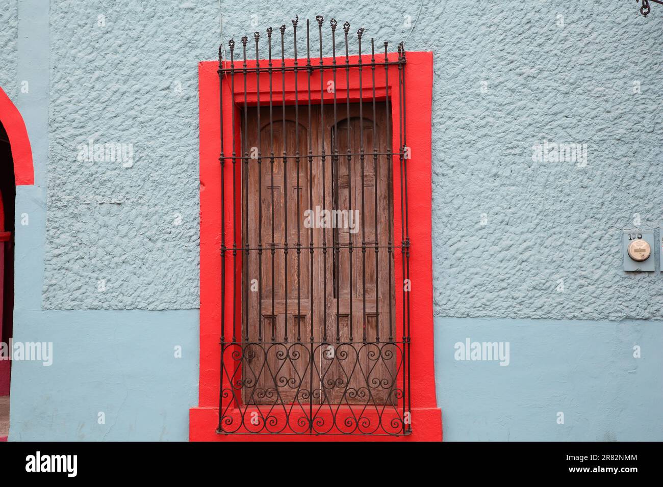 Light blue building with beautiful window and steel grilles Stock Photo ...