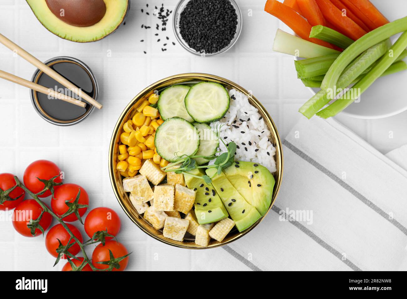 Delicious poke bowl and ingredients on white tiled table, flat lay ...