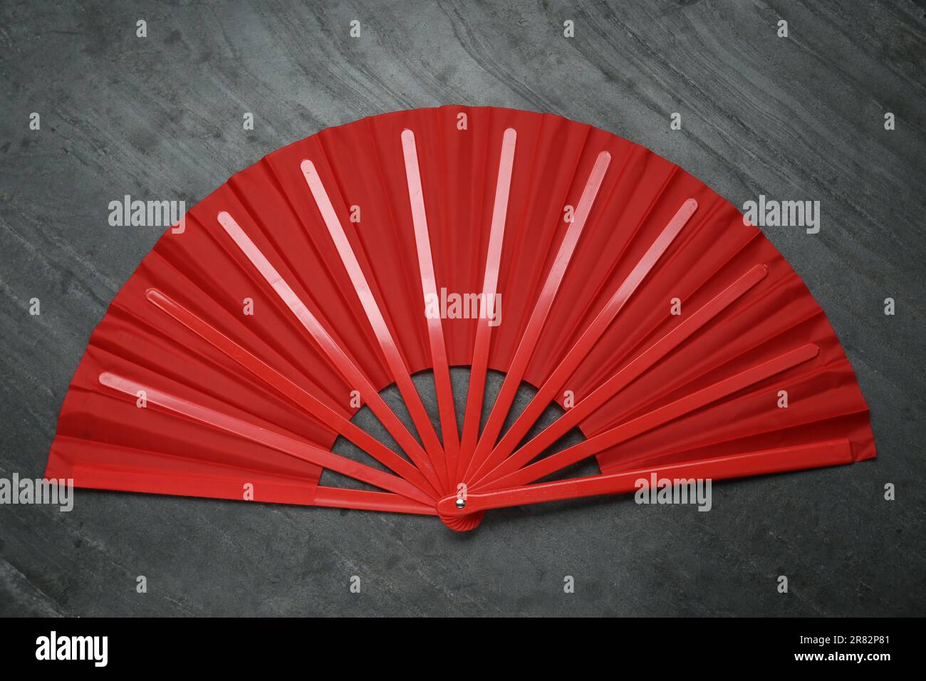Bright red hand fan on grey background, top view Stock Photo - Alamy