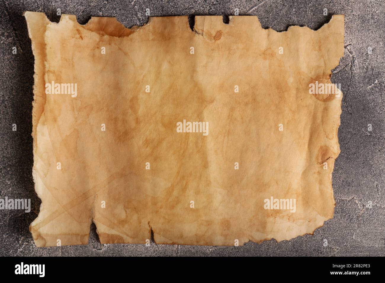 Sheet of old parchment paper on gray textured table, top view Stock ...