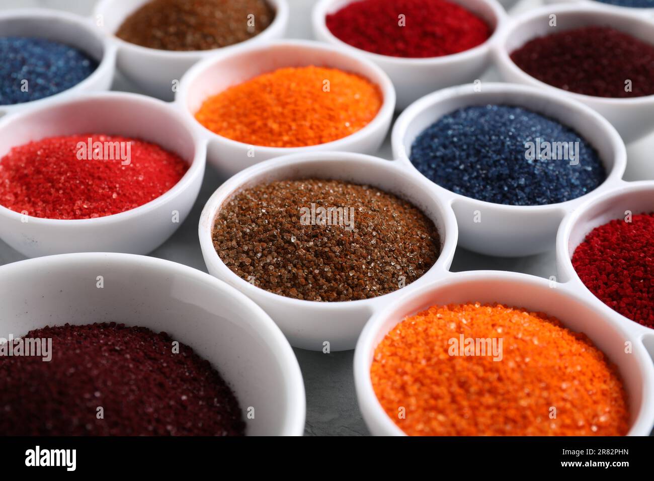 Bowls of different food coloring on light grey table, closeup Stock ...