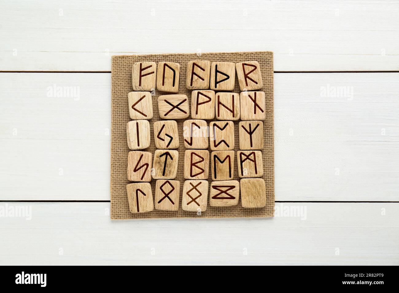 Runes with different symbols on white wooden table, top view Stock ...