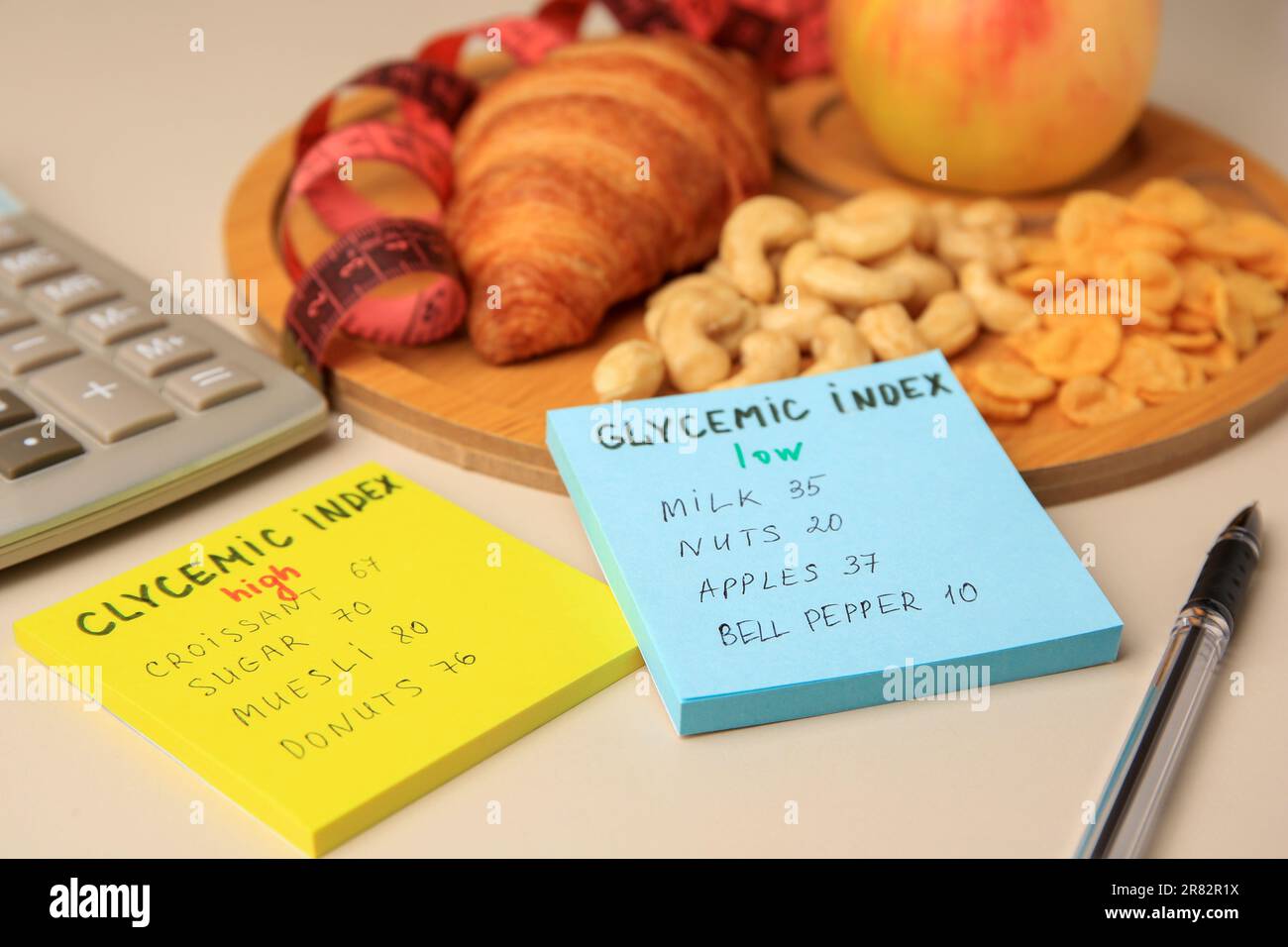 Glycemic index. Notes with information, measuring tape, calculator, pen ...