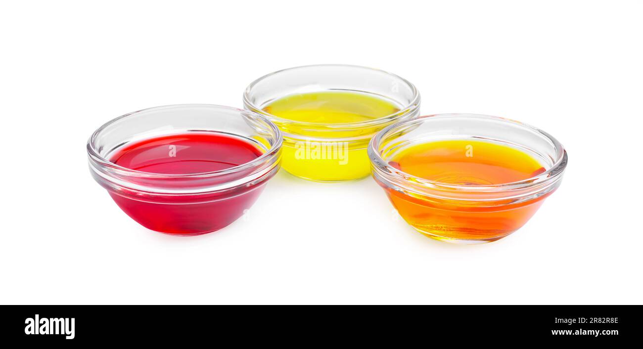 Glass bowls with different food coloring on white background Stock ...