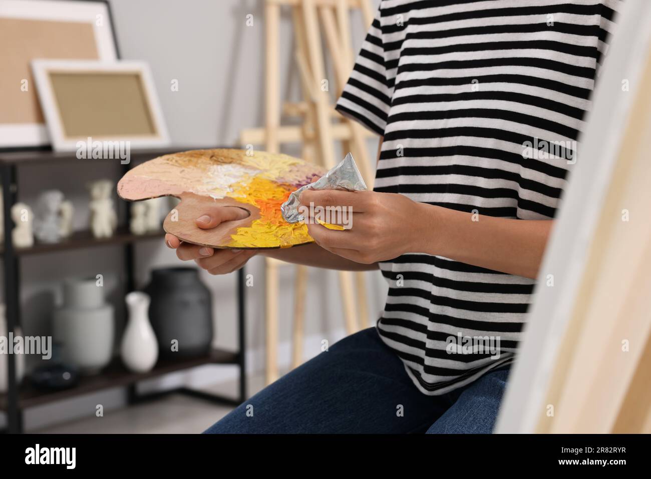Young woman mixing paints on palette in studio, closeup Stock Photo - Alamy