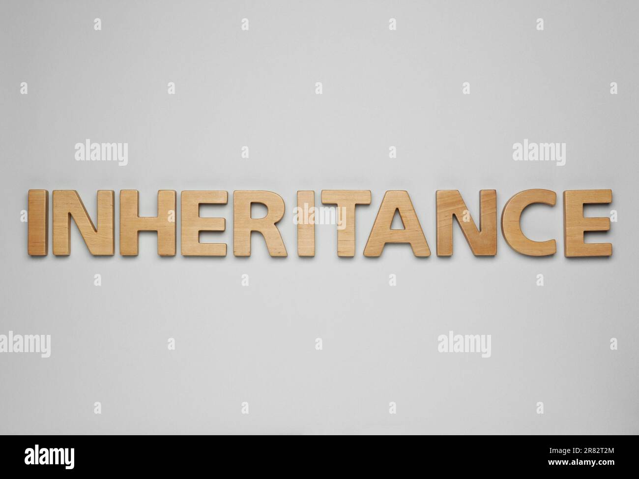 Word Inheritance made with wooden letters on light background, flat lay ...