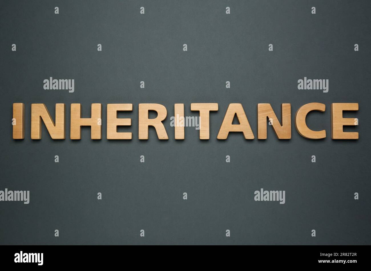 Word Inheritance made with wooden letters on black background, flat lay ...