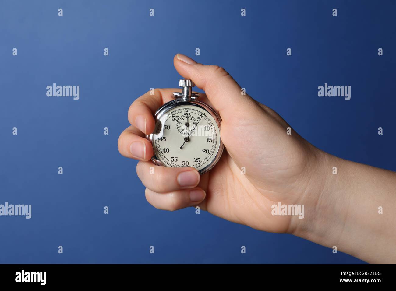 Woman holding vintage timer on blue background, closeup Stock Photo - Alamy
