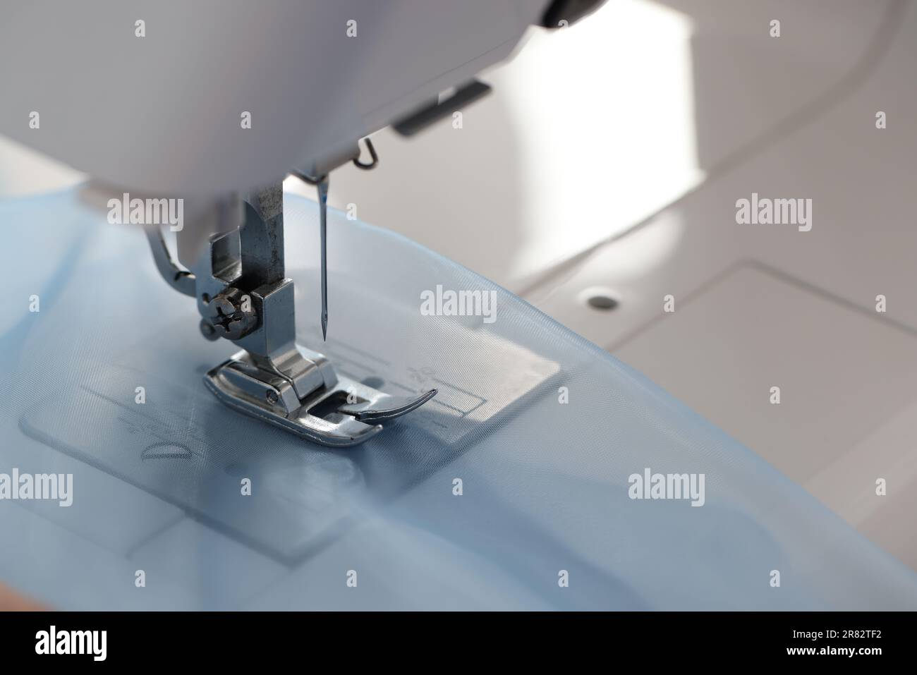Sewing machine with light blue fabric, closeup. Space for text Stock ...
