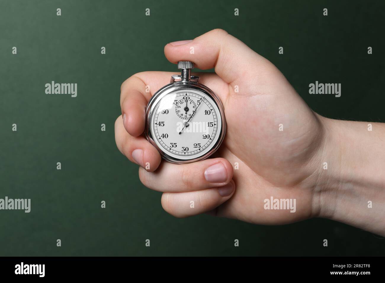 Man holding vintage timer on green background, closeup Stock Photo - Alamy