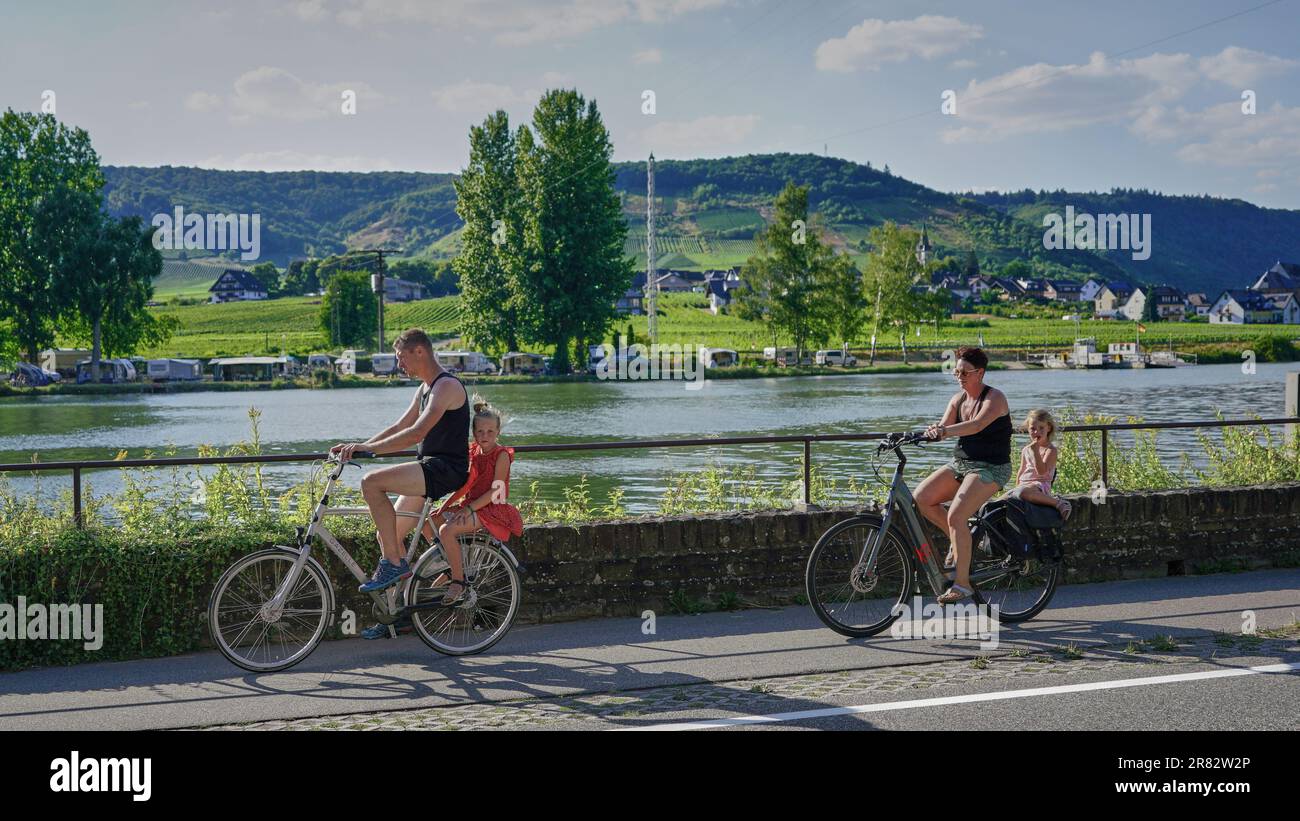Family on bike tour of the Moselle River in Germany. Man, woman and two ...