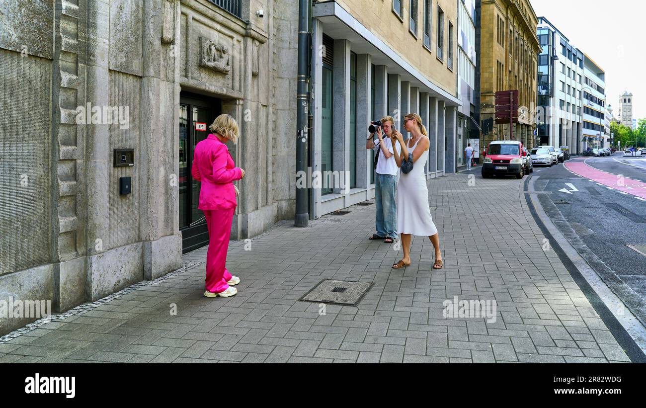 Female in pink pant suit in a fashion photo shoot in downtown Cologne ...