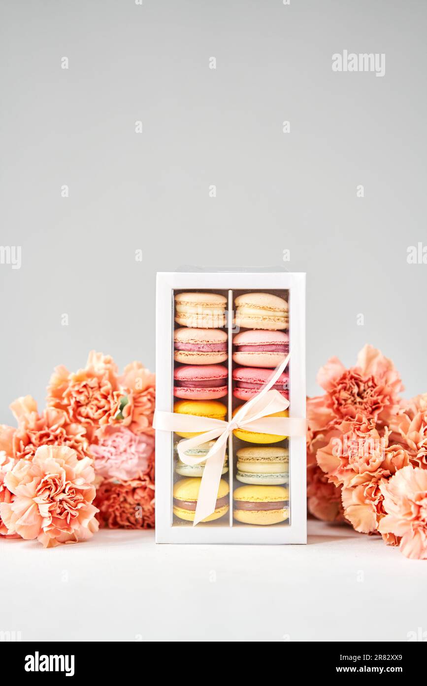 Dessert French Macarons in present box. Sweet dessert on a flowers ...