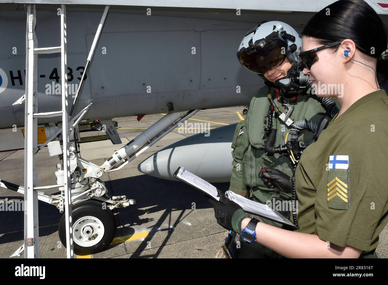 Finnish air force Tech. Sgt. Ella, right, plane captain, reviews ...