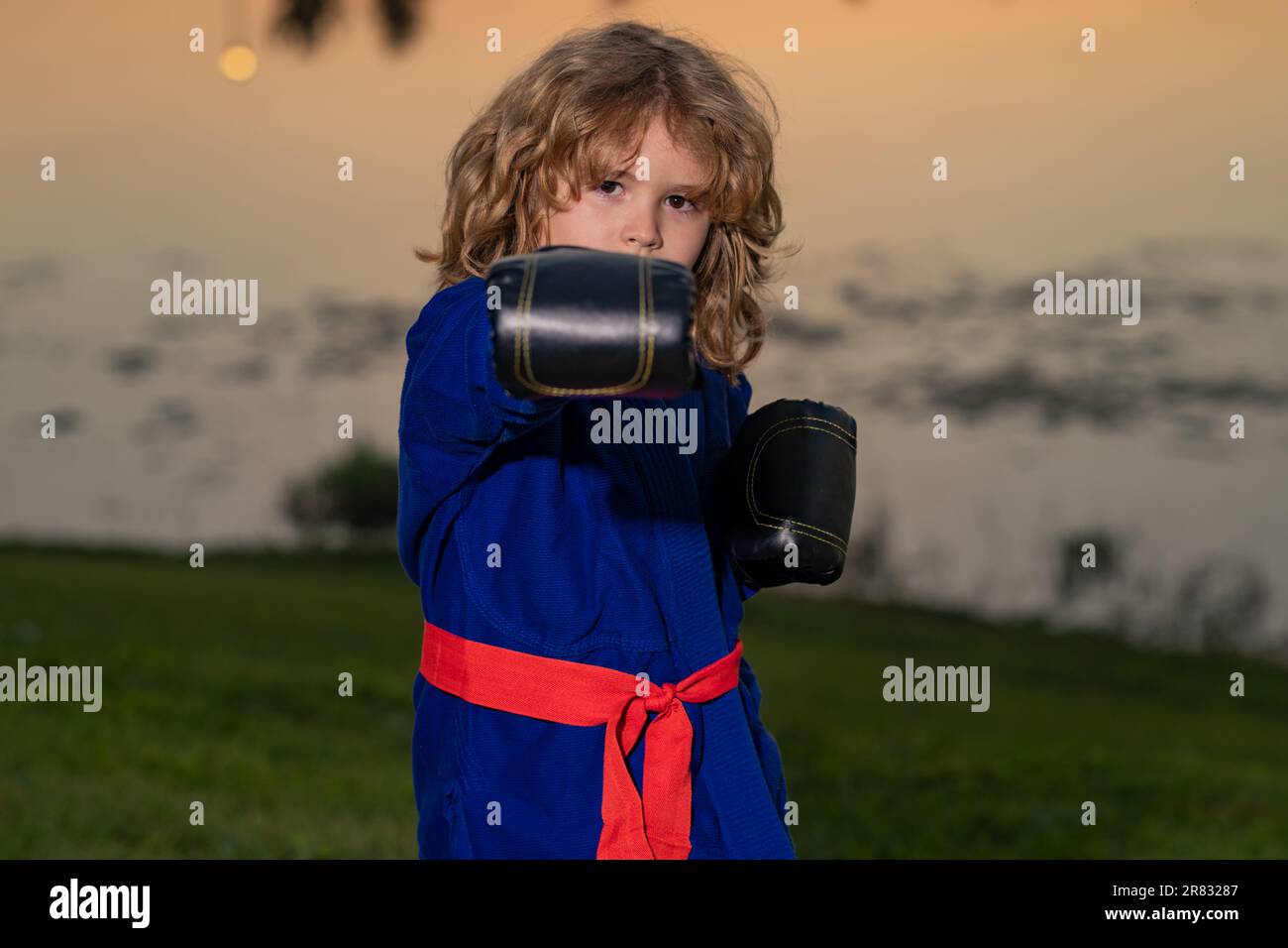 Kid boy practicing box outdoor. Sport karate kids. Little boy in kimono ...