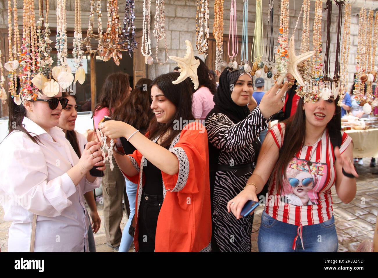 Rashaya, Lebanon. 18th June, 2023. Girls check jewelry items displayed ...