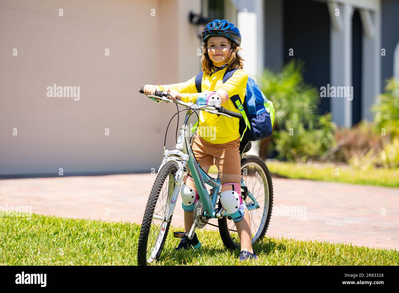 Boy in a helmet riding bike. Boy in safety helmet riding bike in city ...
