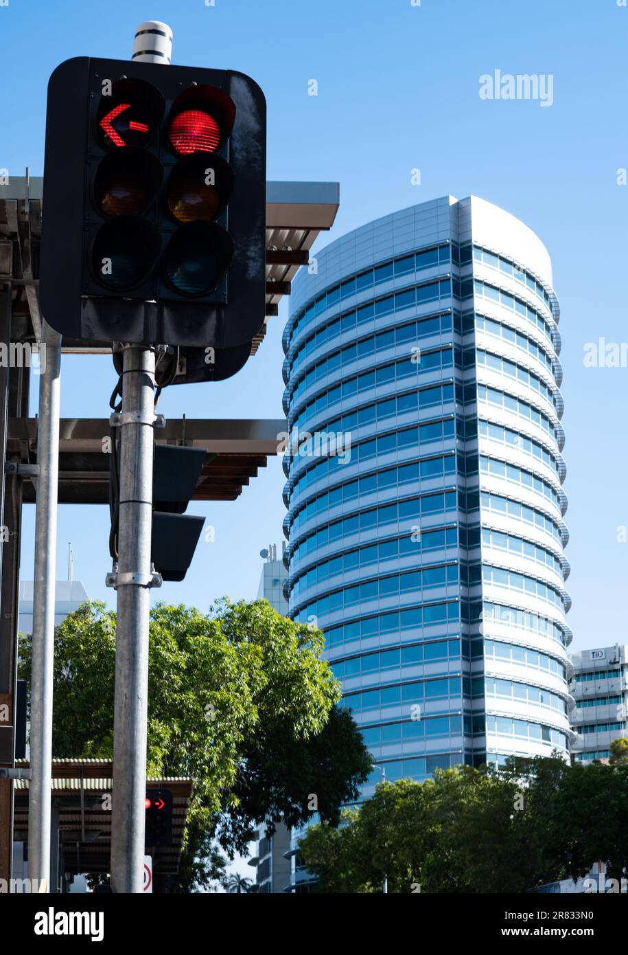 A red traffic light commands driver attention in the foreground. The ...