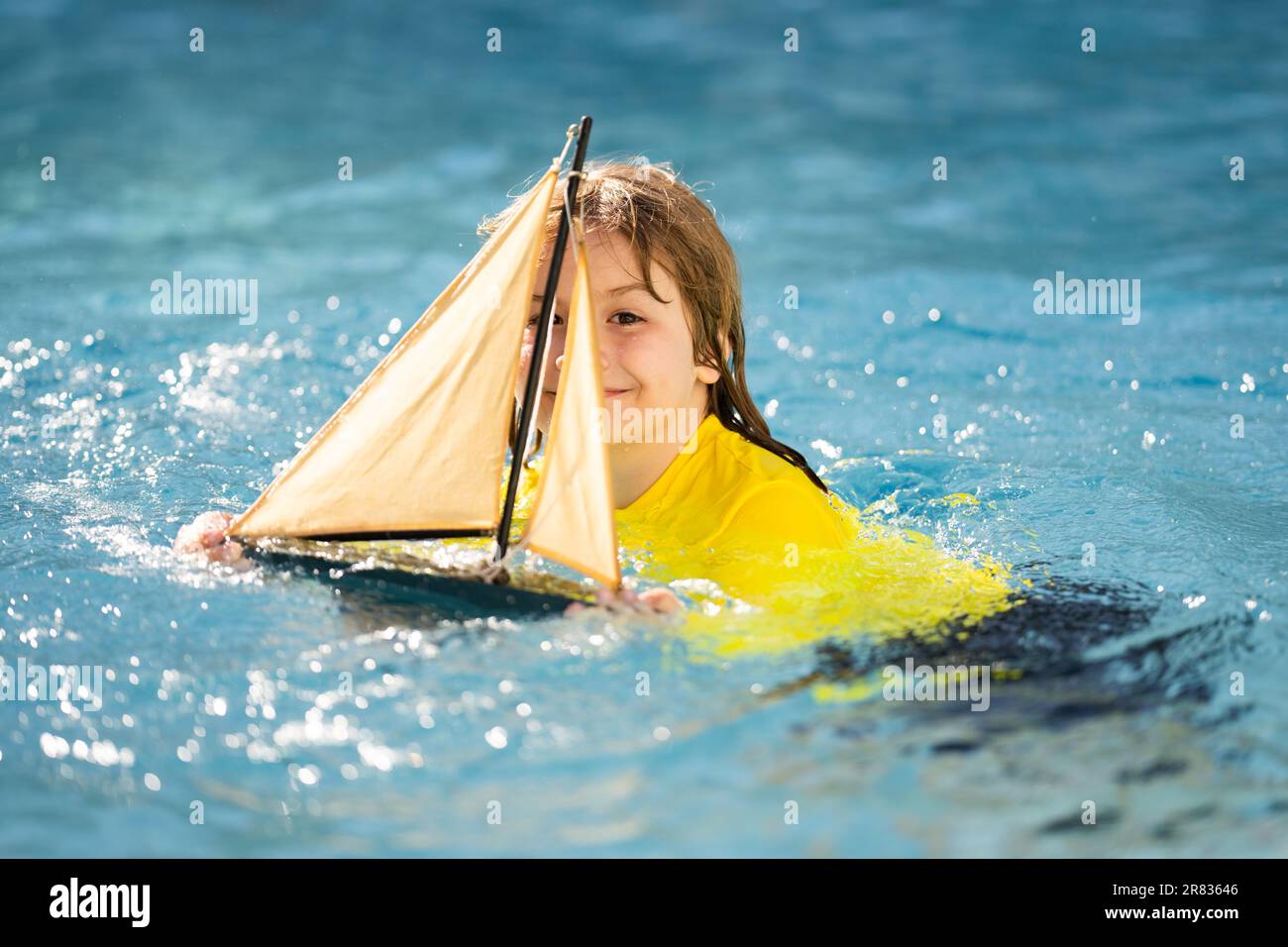 Kid playing with toy sailing boat, toy ship. Travel and adventure ...