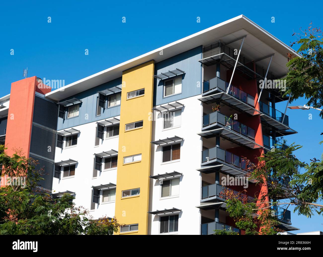 A multi-colored apartment building displaying a uniquely narrow design ...