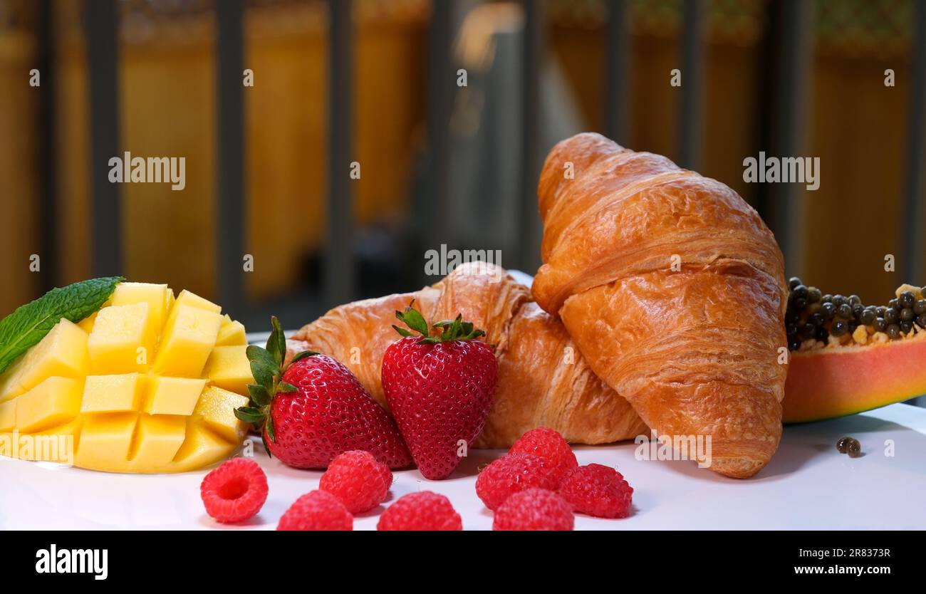 delicious croissant with fruits on a white plate serving cleanliness ...