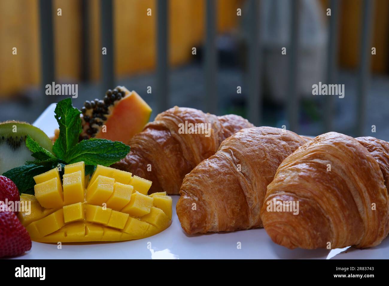 delicious croissant with fruits on a white plate serving cleanliness ...