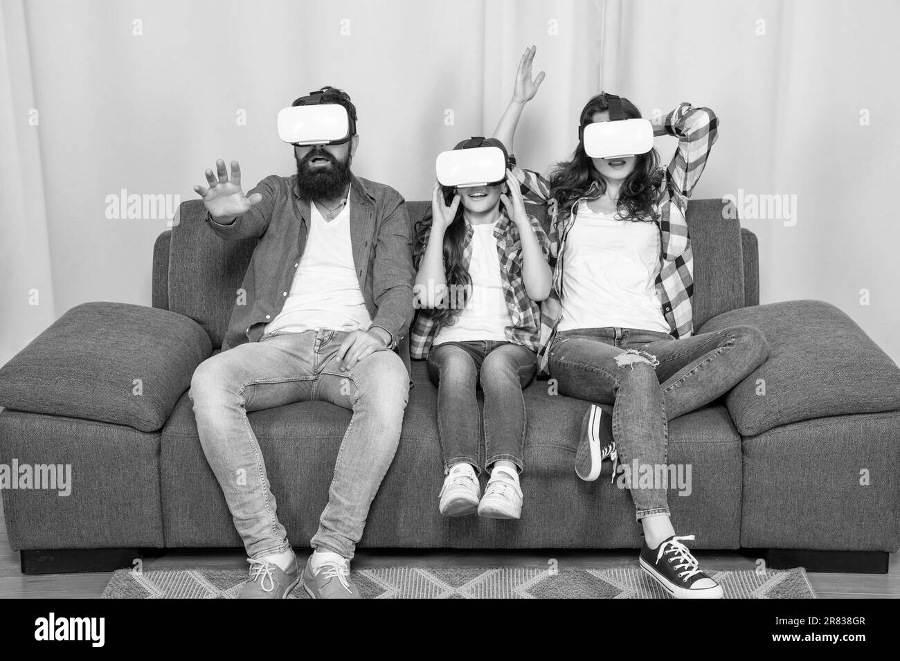 modern life. father mother and child wireless VR glasses. virtual ...