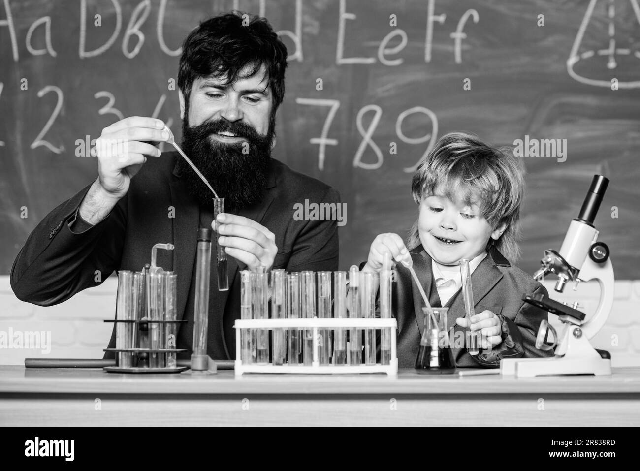 bearded man teacher with little boy. biotechnoloy research concept ...