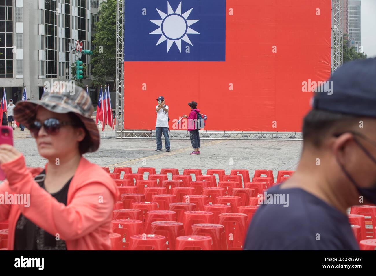 People take pictures in front of the Taiwanese flag at a veterans event ...