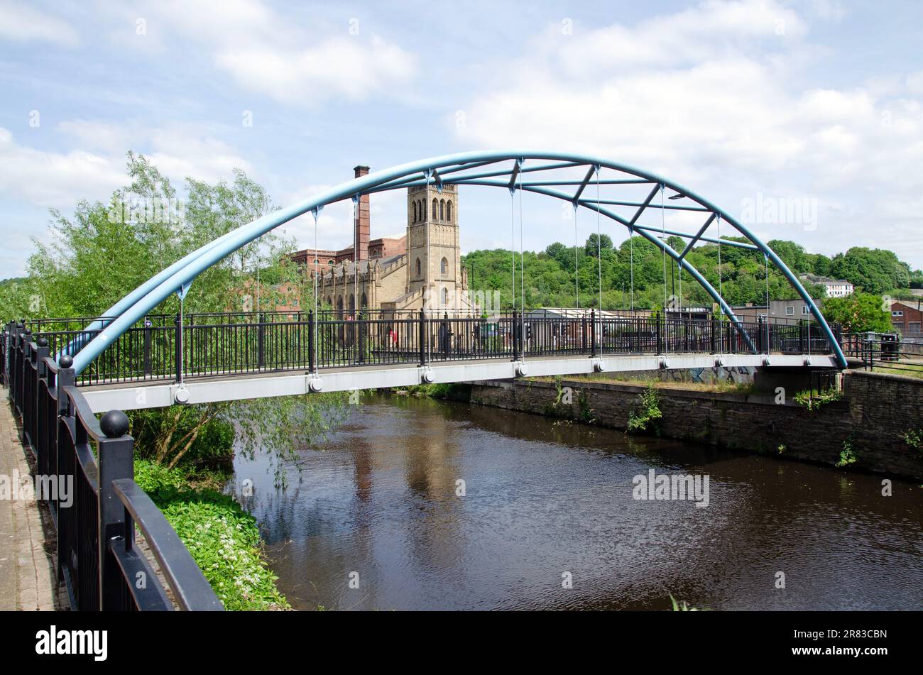 Metal pedestrian bridge across a river. Arch bridge Stock Photo - Alamy