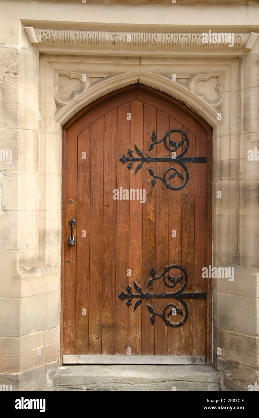 Full frame image of a wooden church door with elaborate metal hinges ...