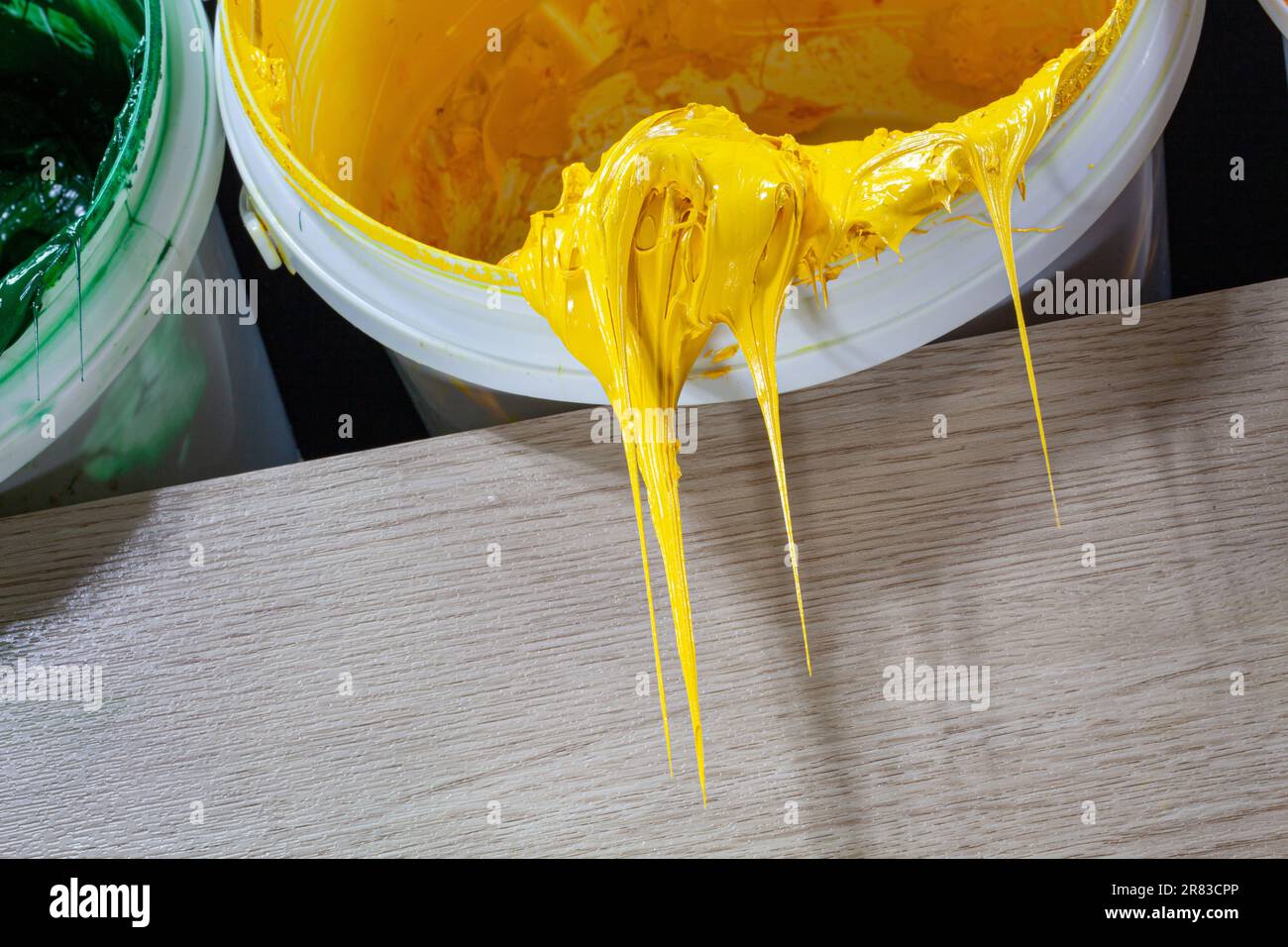 Yellow paint dripping from white barrel. plastisol ink is used for ...