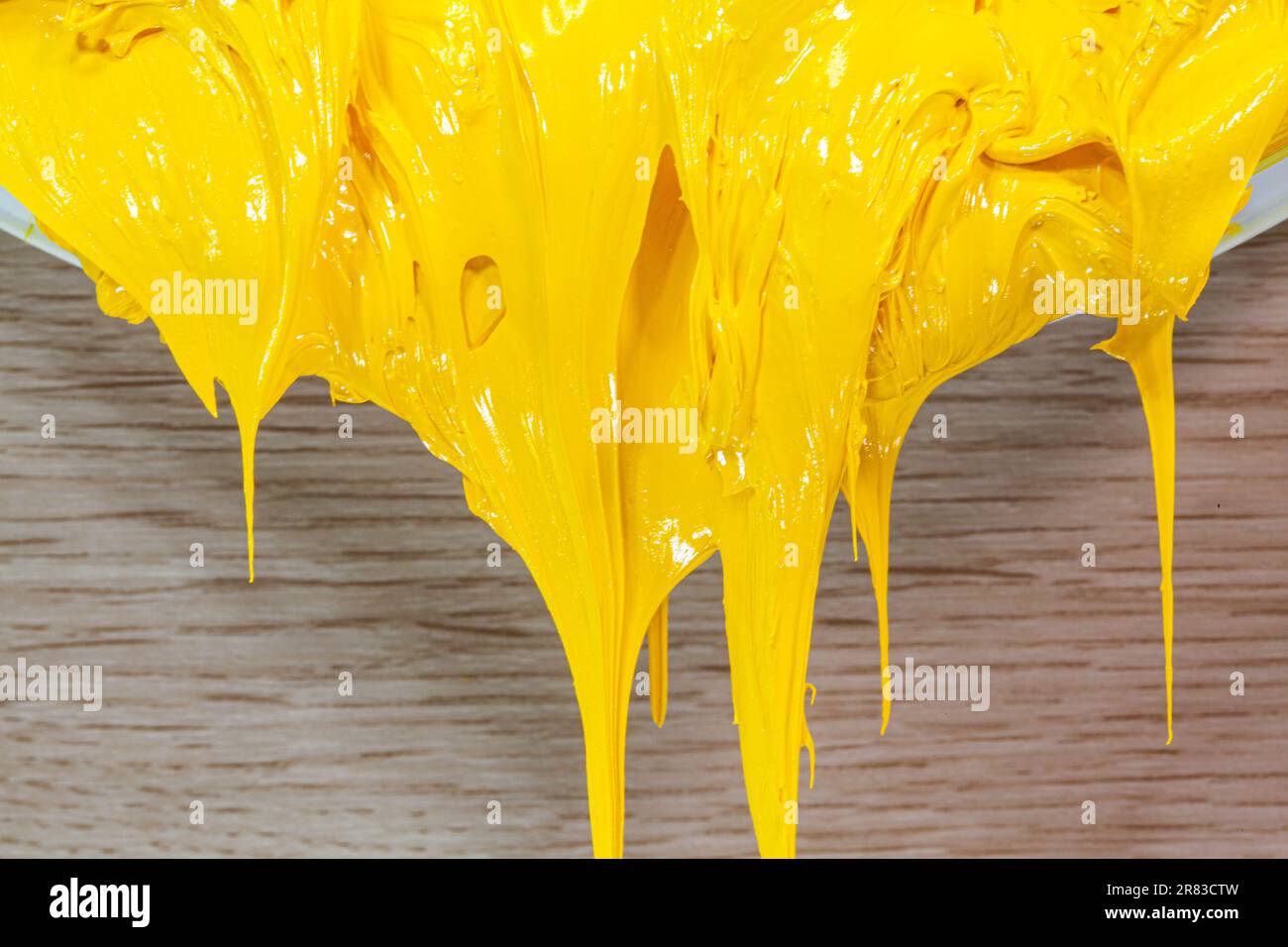 Yellow paint dripping from white barrel. plastisol ink is used for ...