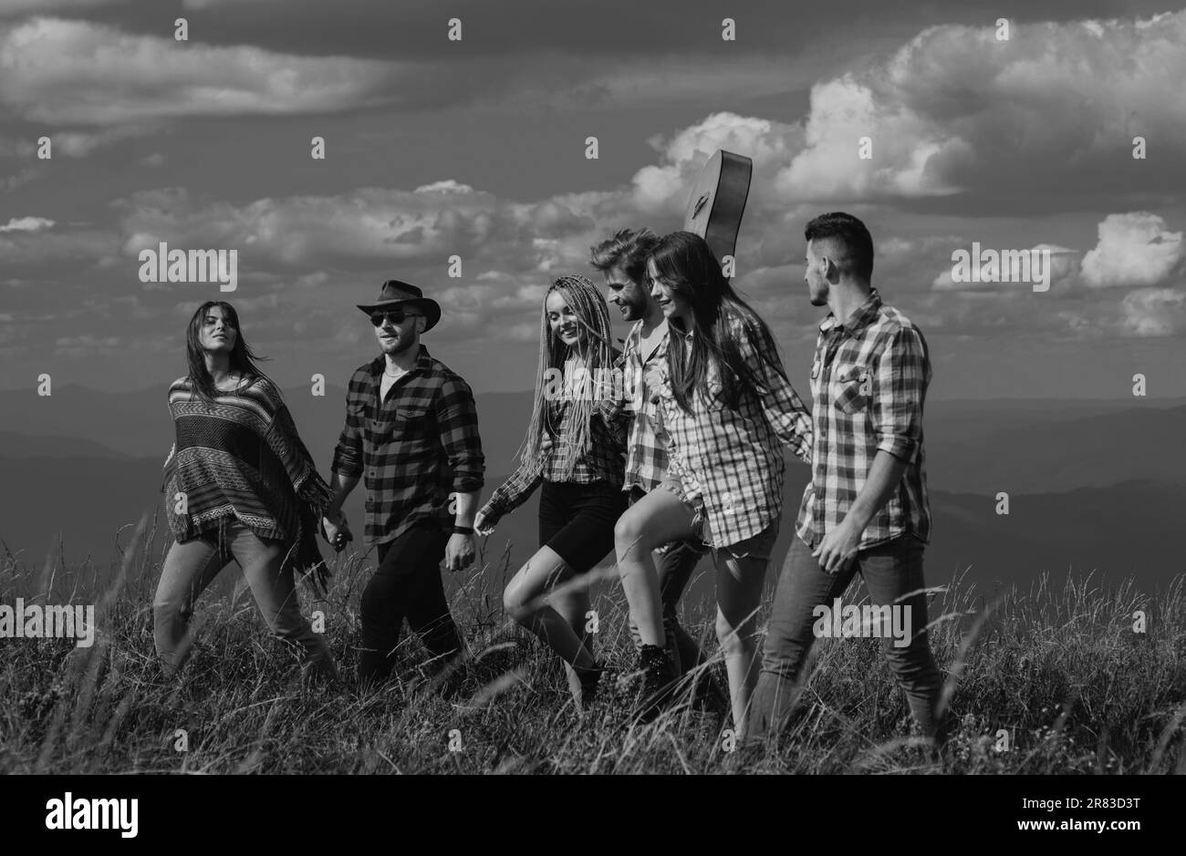Young people on mountain hike. Group of friends go to mountains journey ...