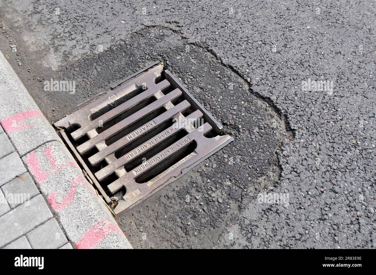 Road damage due to frost, potholes, manhole covers Stock Photo - Alamy