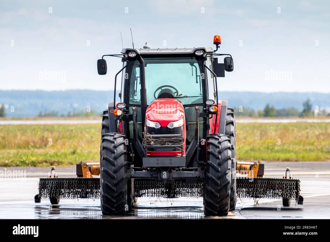 Front view of the wheel tractor with lawn mower on the road Stock Photo ...