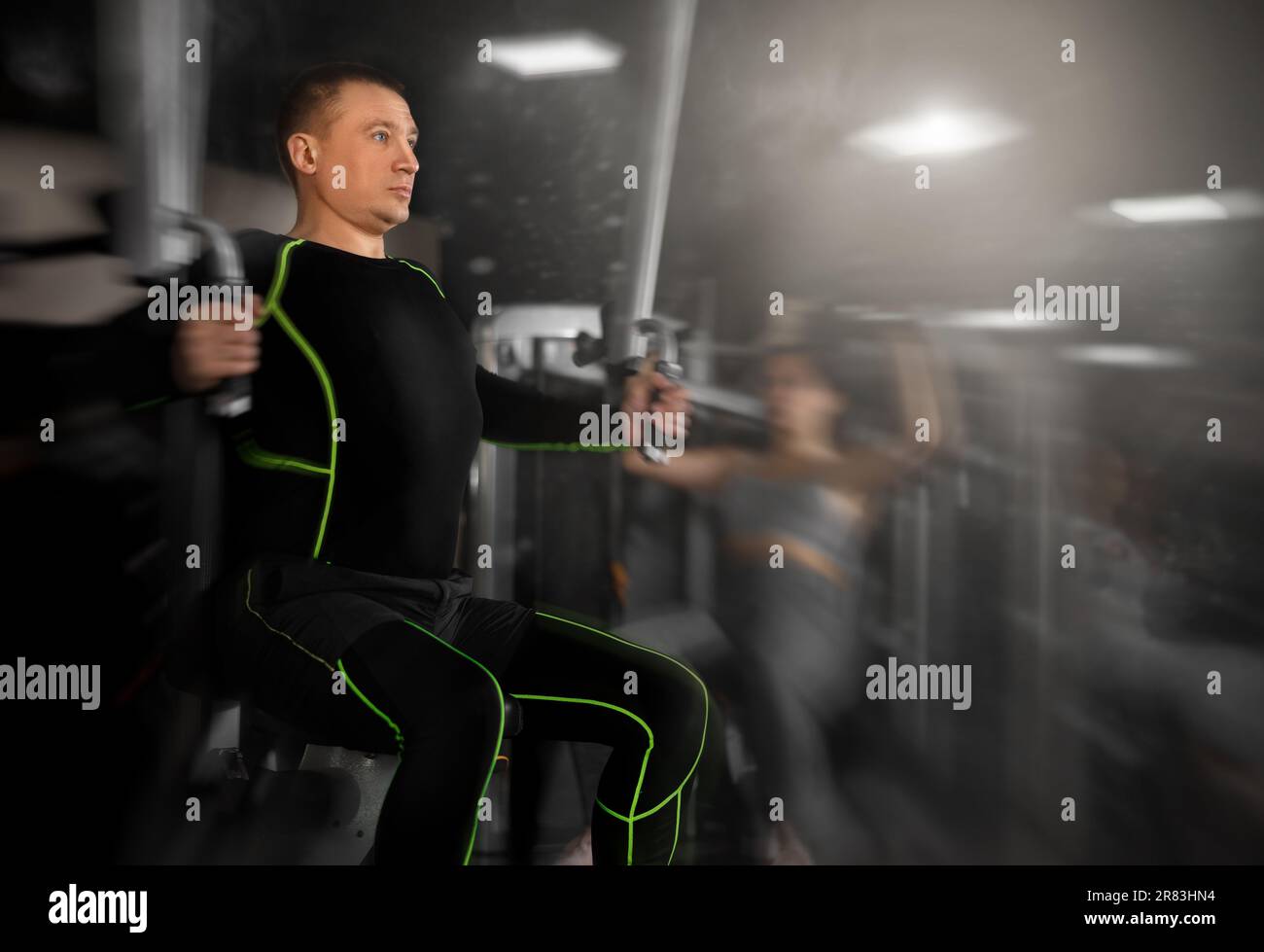 Adult man performing chest exercises on pec deck machine Stock Photo ...