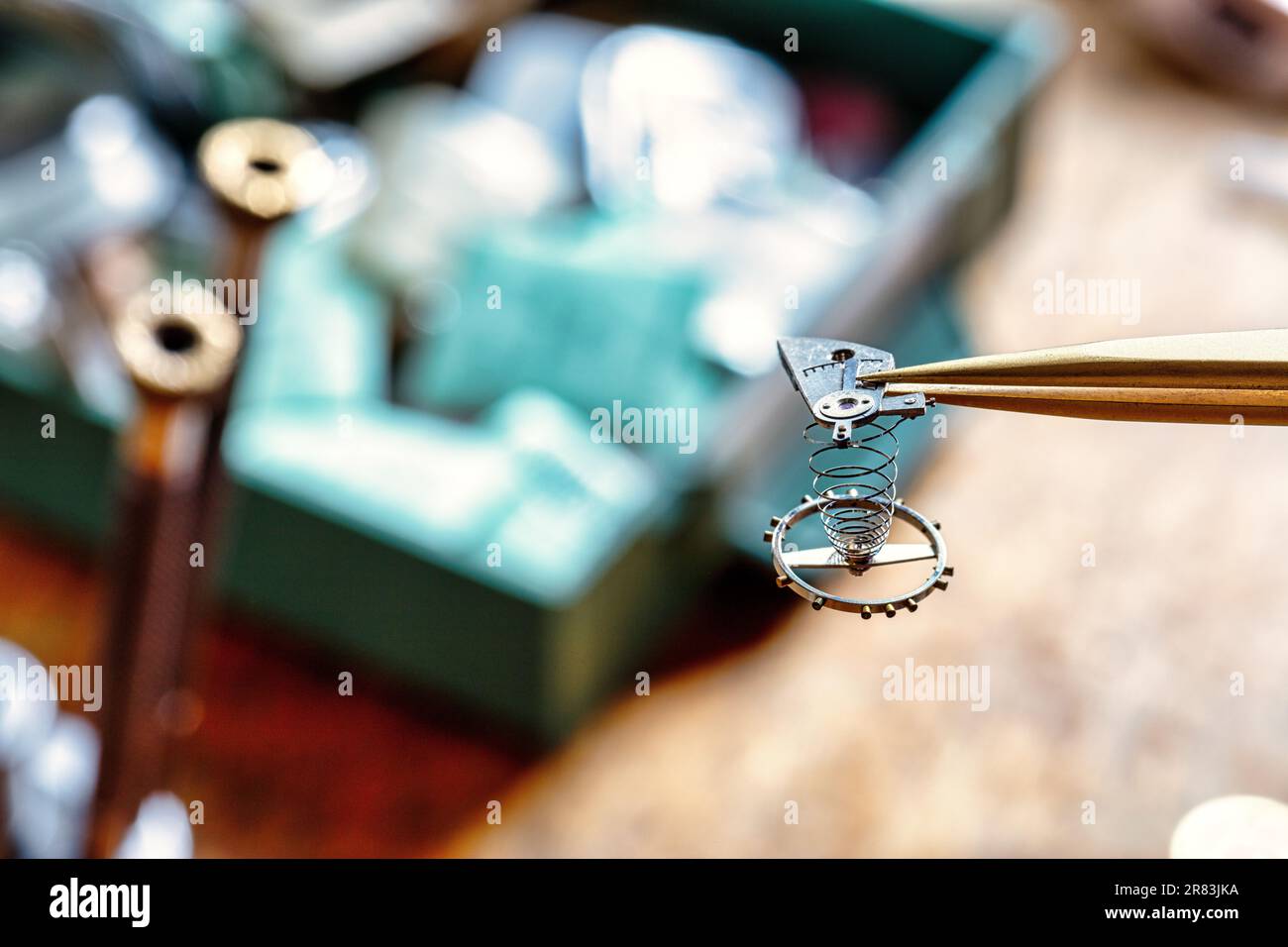 Watches, gears, springs, metal mechanisms, jewels, and wood on a ...