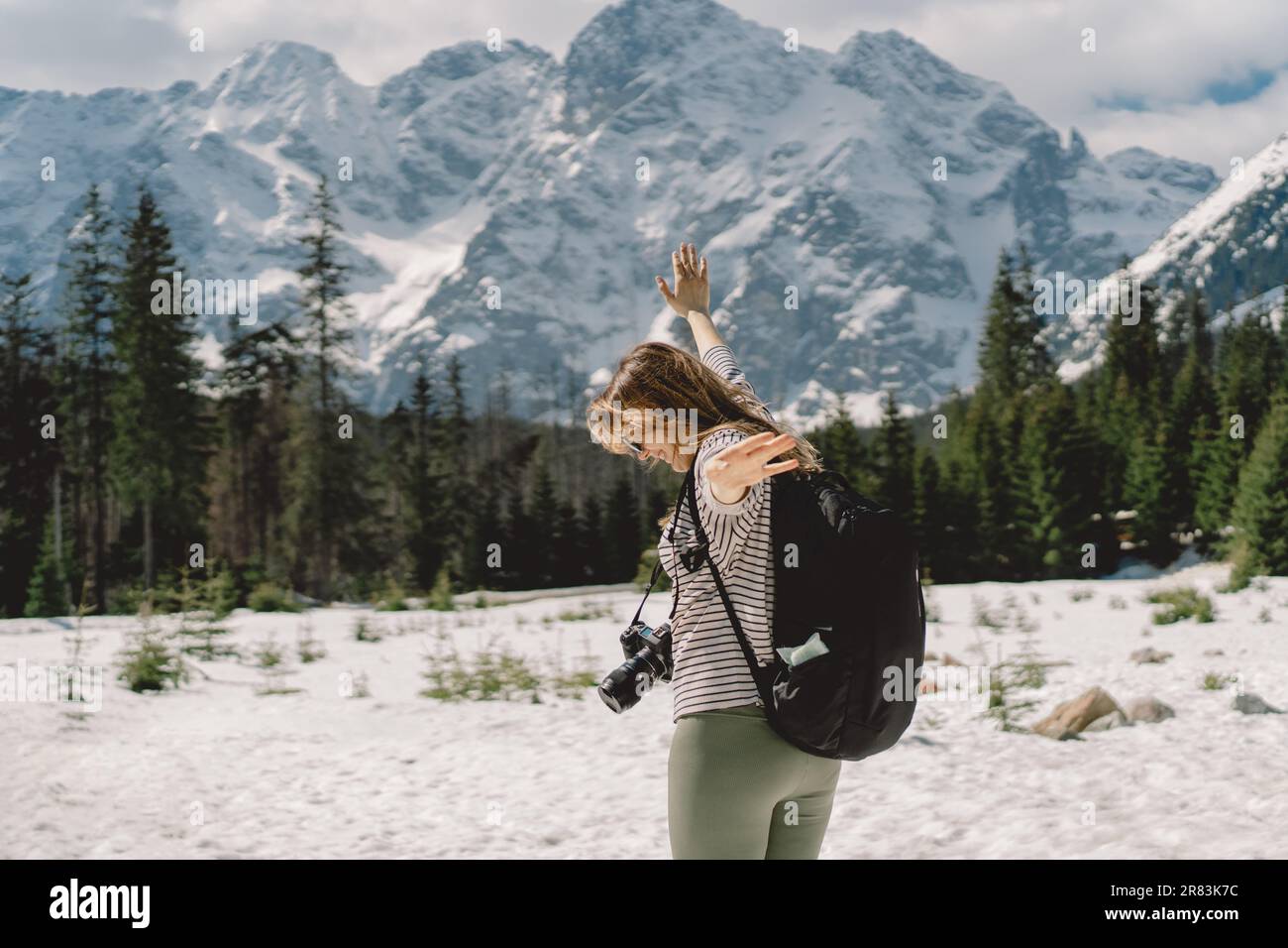 Back view of a girl traveler wearing a backpack traveling alone Stock ...