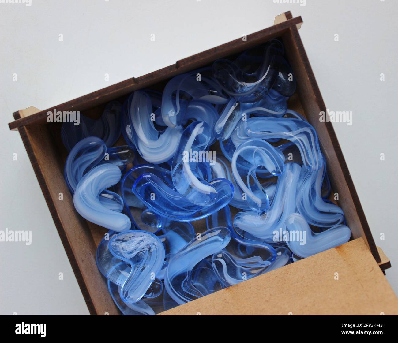 Painted Plywood Box With Blue Artificial Stones On White Surface Top ...