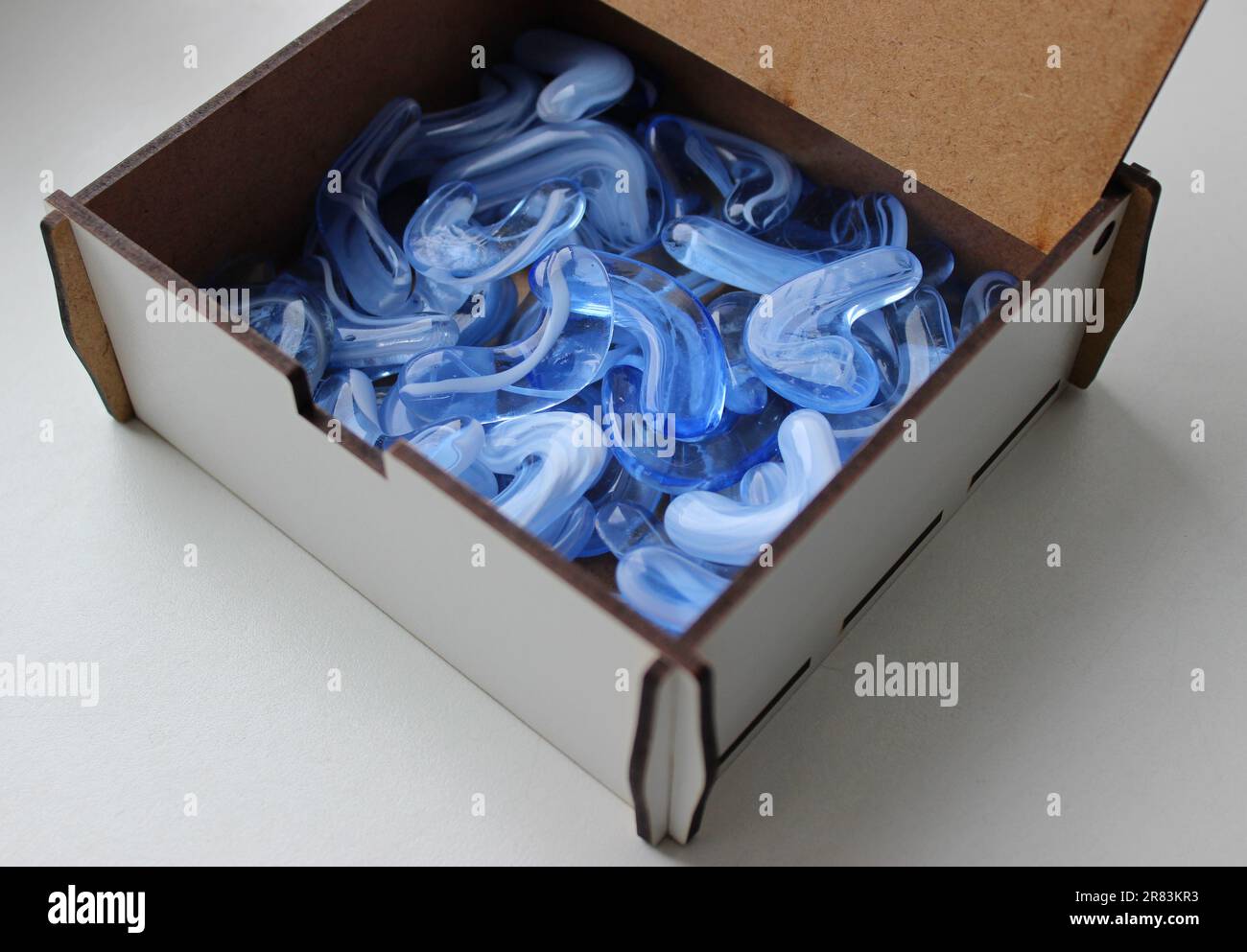 Blue Smoky Glass Stones Inside A Wooden Jewelry Box Isolated On White ...