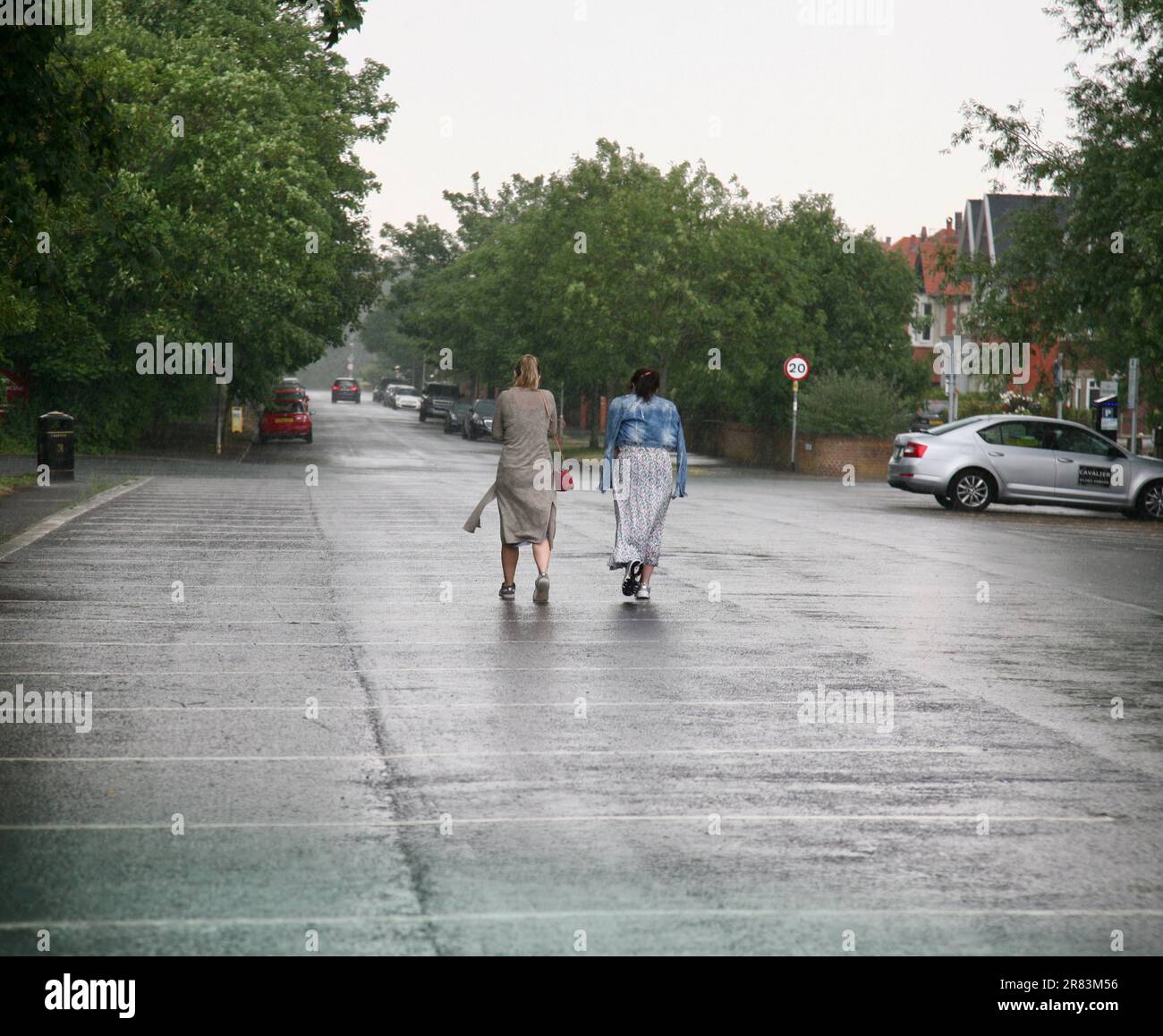 Two ladies caught under a rain cloud Stock Photo - Alamy