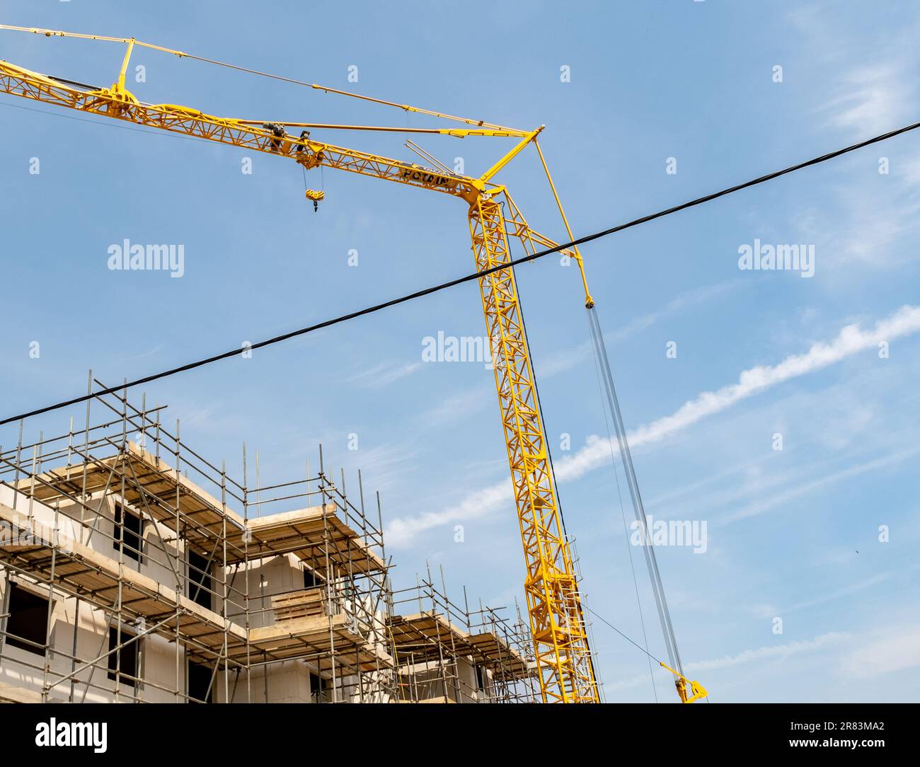 Semi built flats and crane on a construction site. Captured on a bright ...