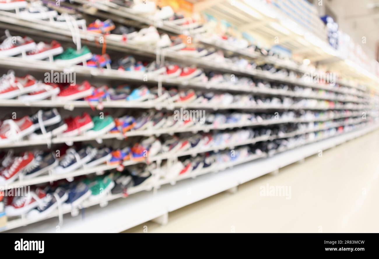 Abstract blur sport shoes on shelves in sneakers shop store background ...