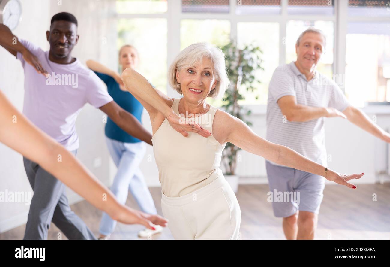 Mature men and women practicing Hip-hop dance in training hall Stock ...