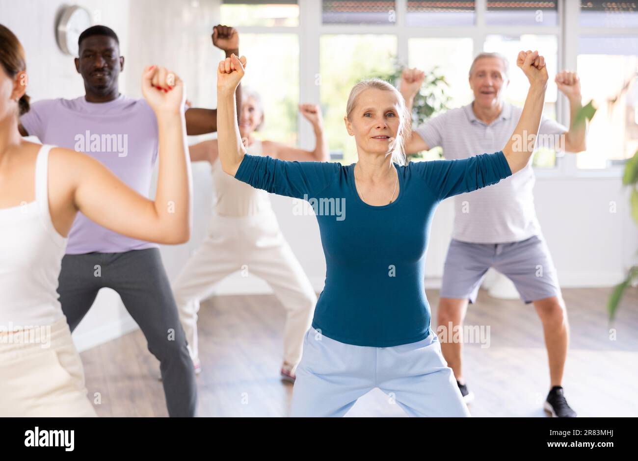 Elderly woman dancing hip hop during group dance class Stock Photo - Alamy