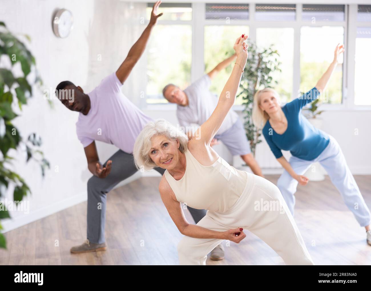 Elderly woman dancing hip hop during group dance class Stock Photo - Alamy