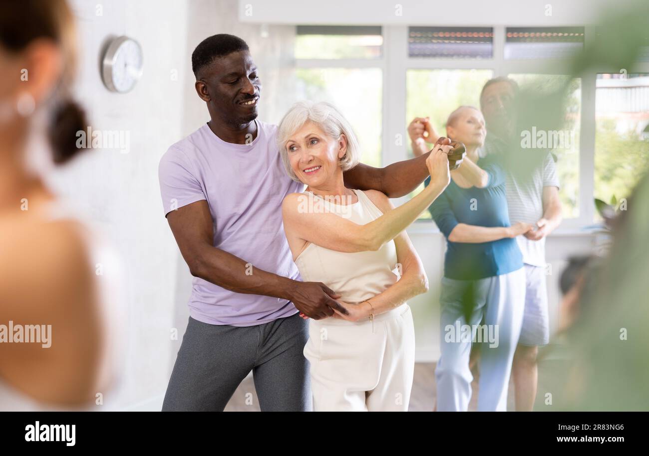 Group of multiethnic mature people dancing social dance Stock Photo - Alamy