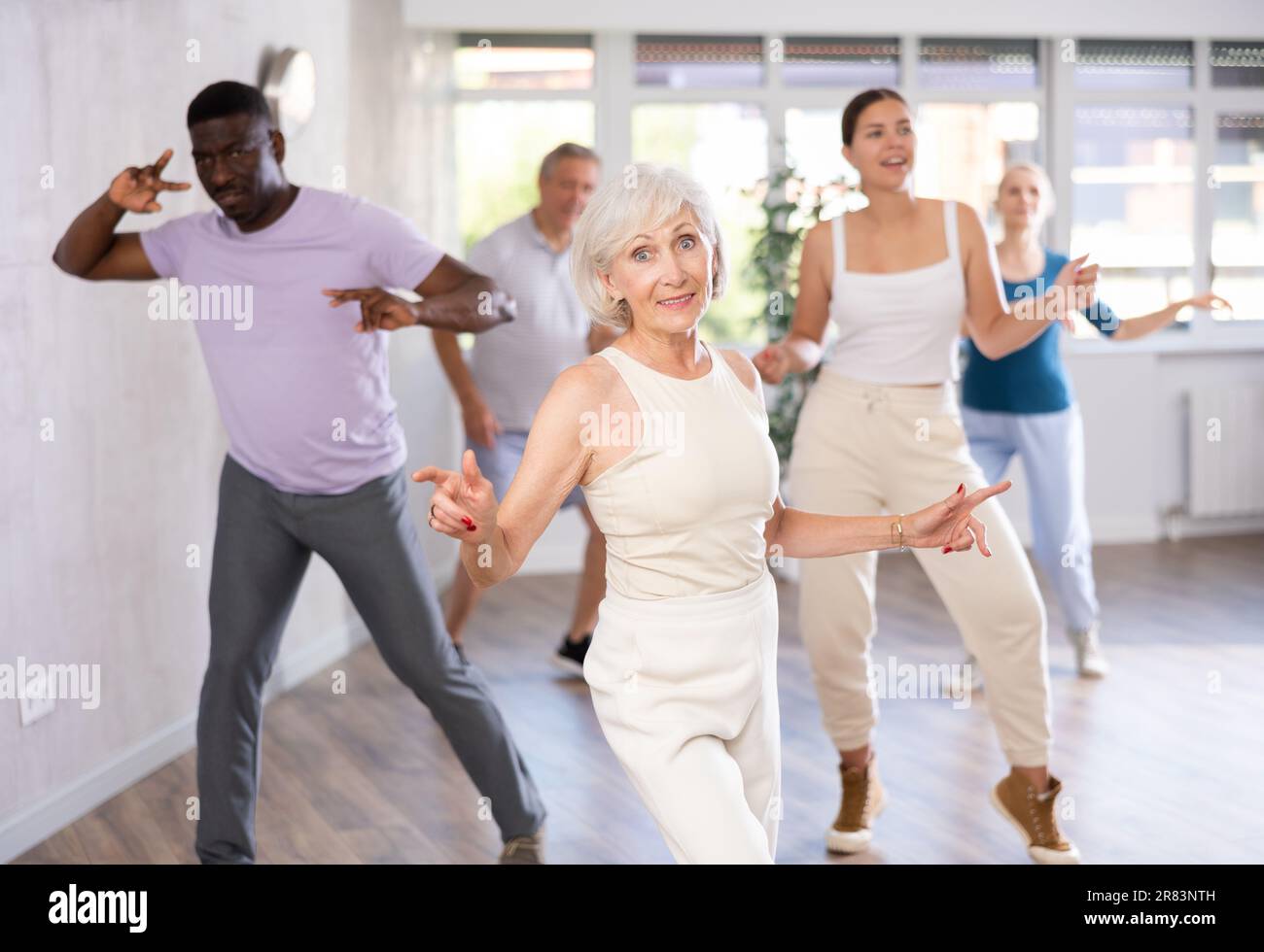 Senior woman dancing vintage twist in modern dance studio Stock Photo ...